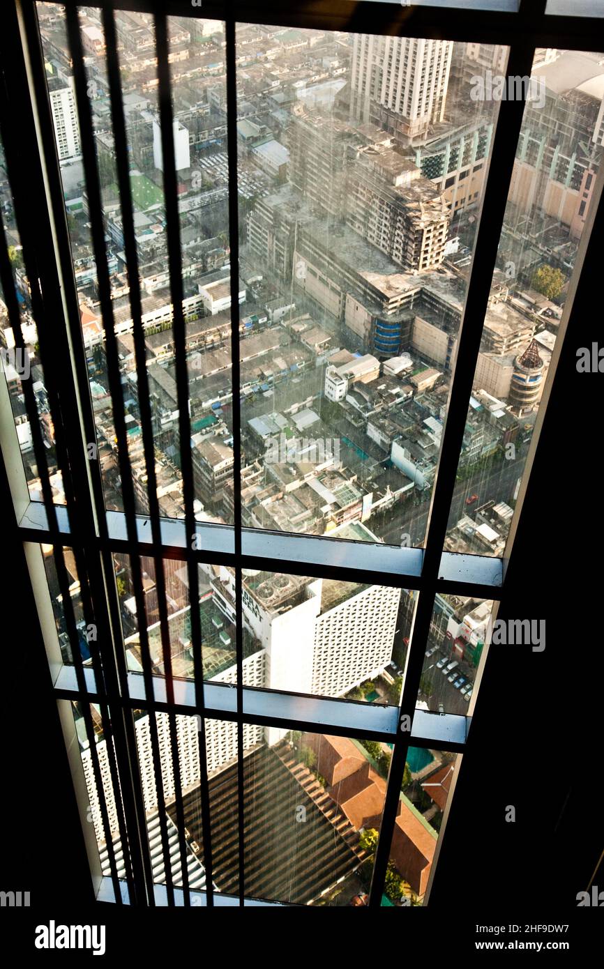 View from an outside elevator across Bangkok skyline showing office ...