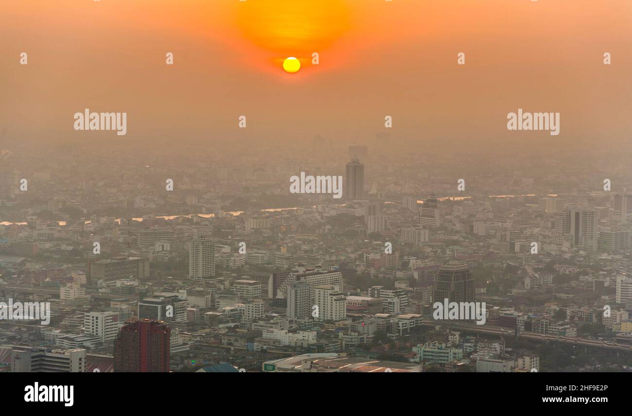 View across Bangkok skyline showing in sunset with smog and dust in the ...