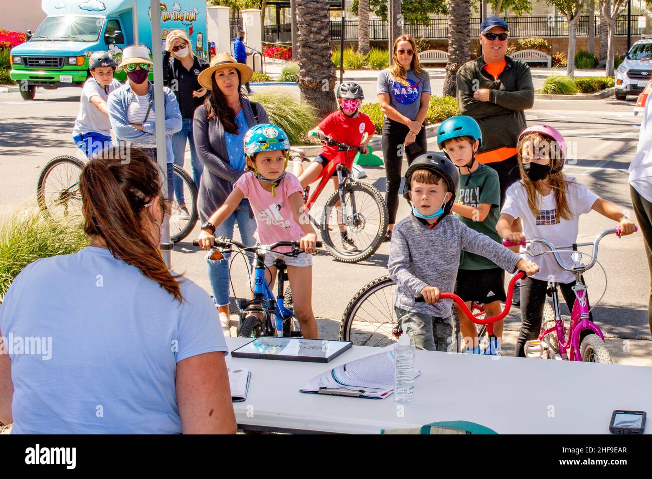 Helmet-wearing children gather in a suburban Southern California park ...
