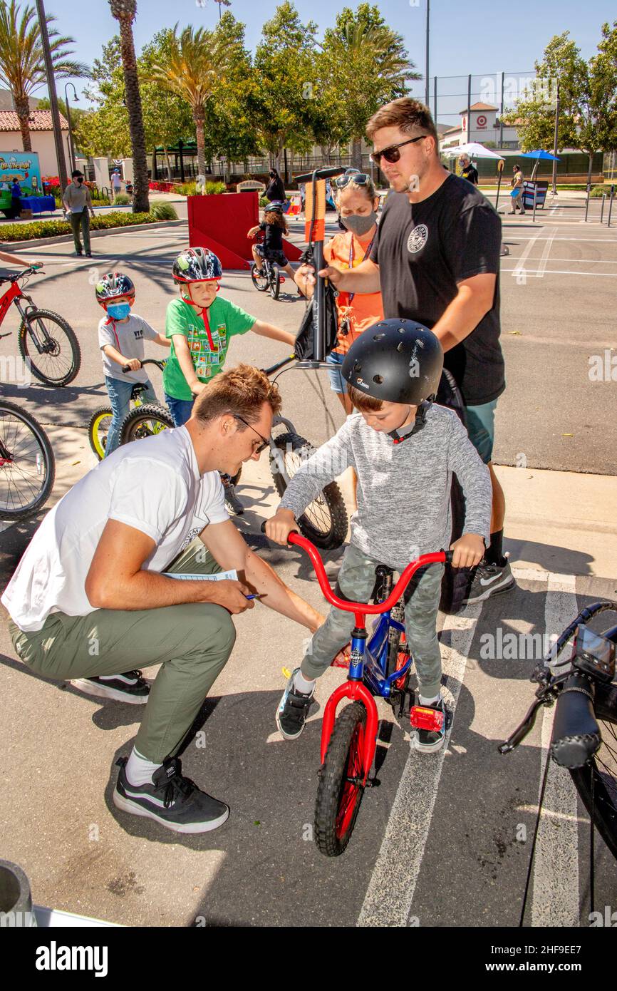 Helmet-wearing children gather in a suburban Southern California park ...