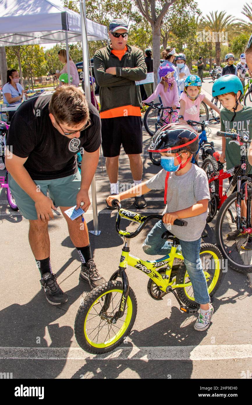 Helmet-wearing children gather in a suburban Southern California park ...