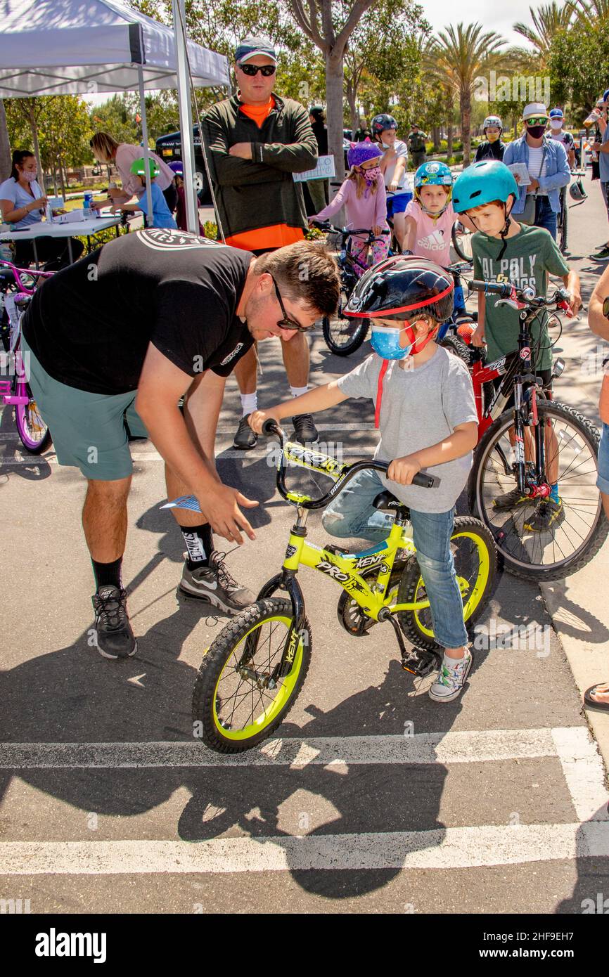 Helmet-wearing children gather in a suburban Southern California park ...