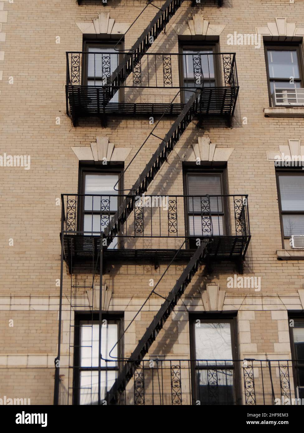 Fire escape ladders on New York appartment buildings Stock Photo - Alamy