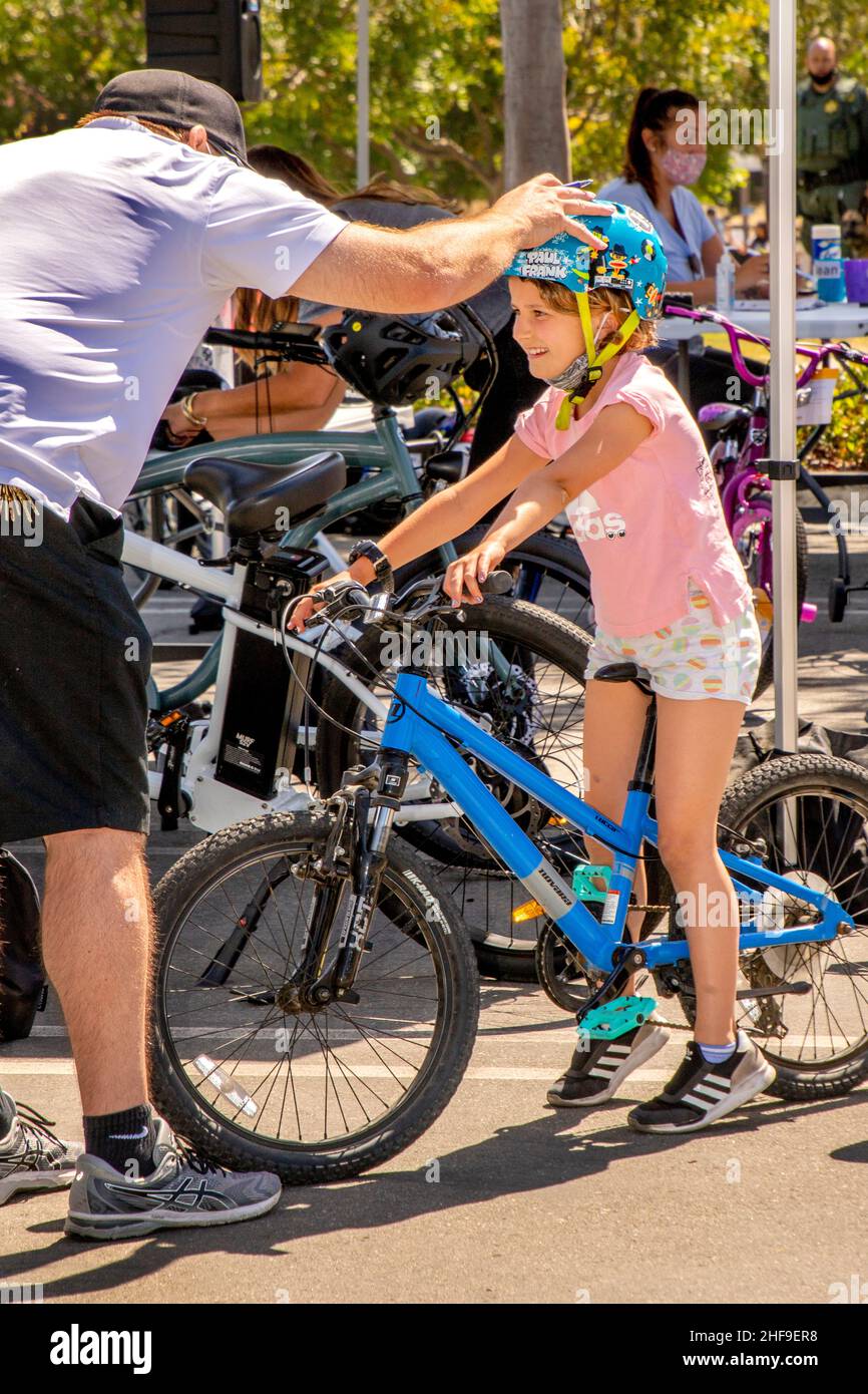 Helmet-wearing children gather in a suburban Southern California park ...