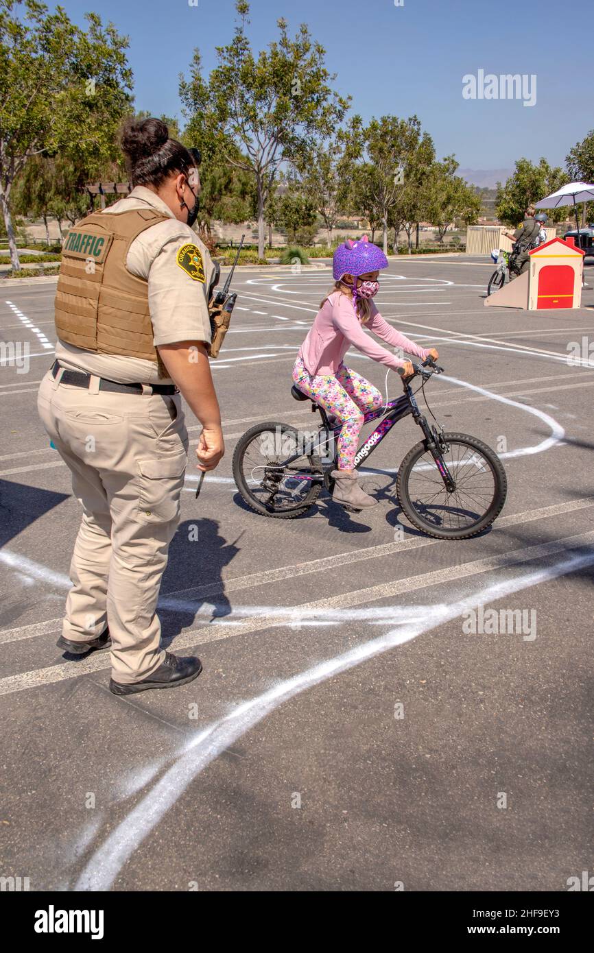 Helmet-wearing children gather in a suburban Southern California park ...