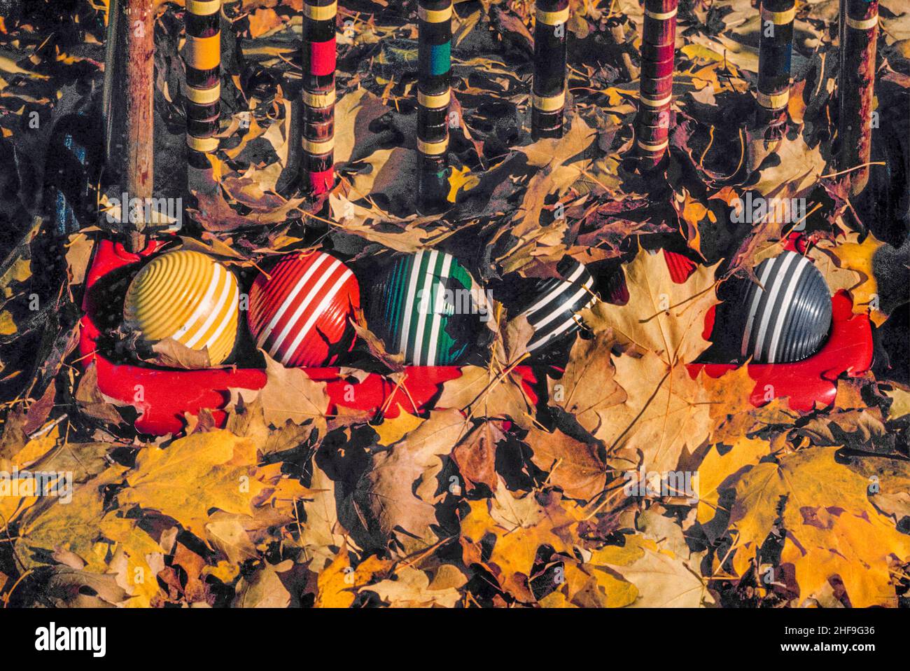 A colorful croquet set including balls and mallets is surrounded by ...