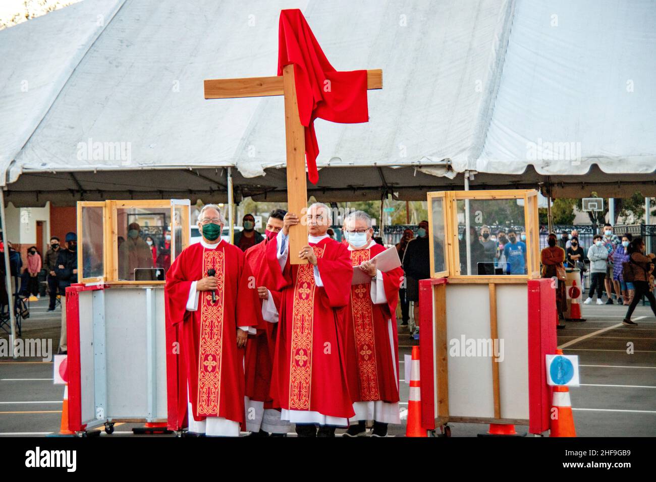 As part of an outdoor mass, multiracial robed priests form a procession ...