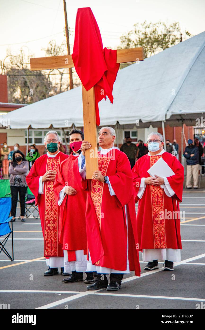 As part of an outdoor mass, multiracial robed priests form a procession ...