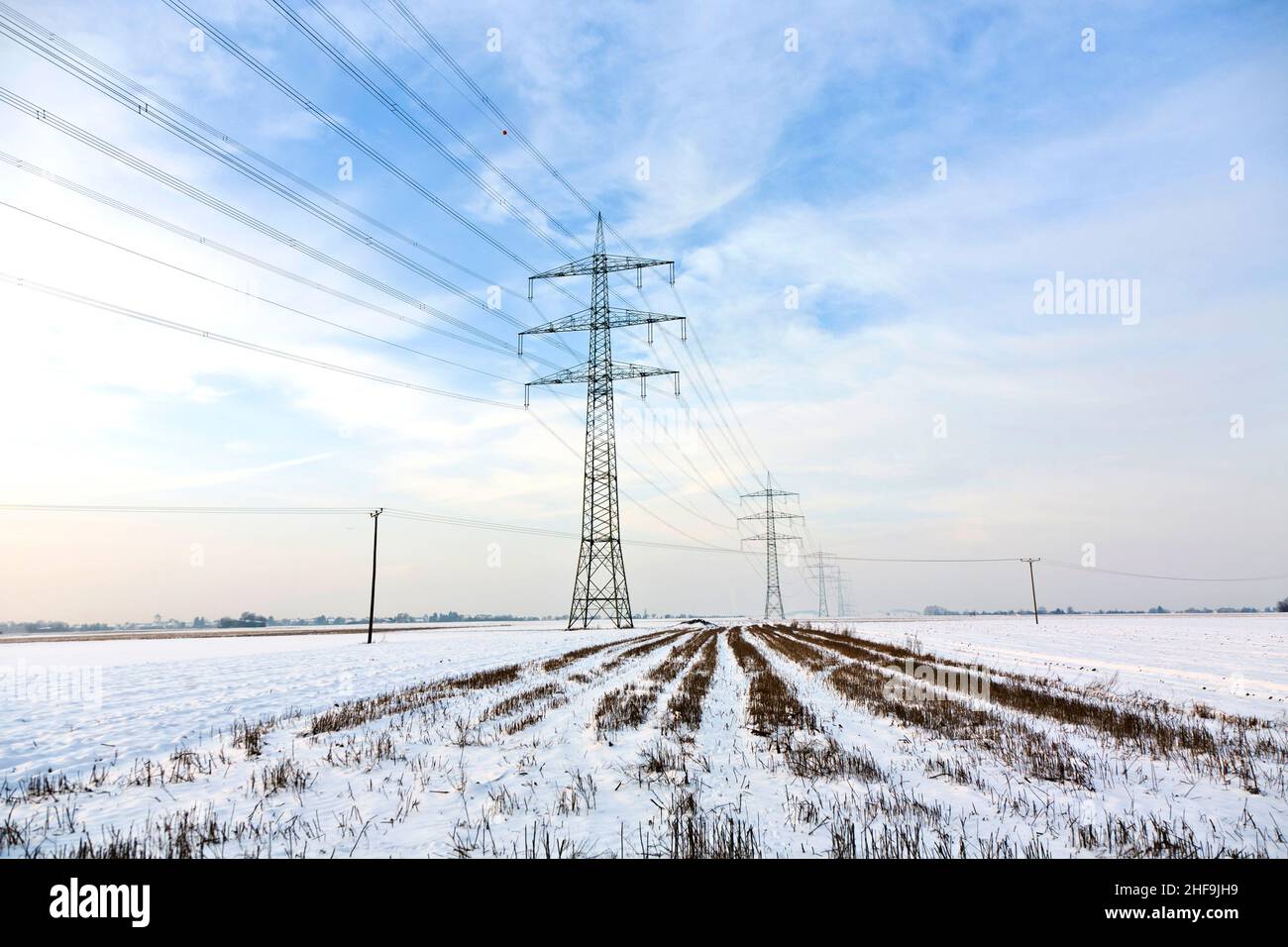 electrical tower in wintertime with snow covered fields Stock Photo - Alamy