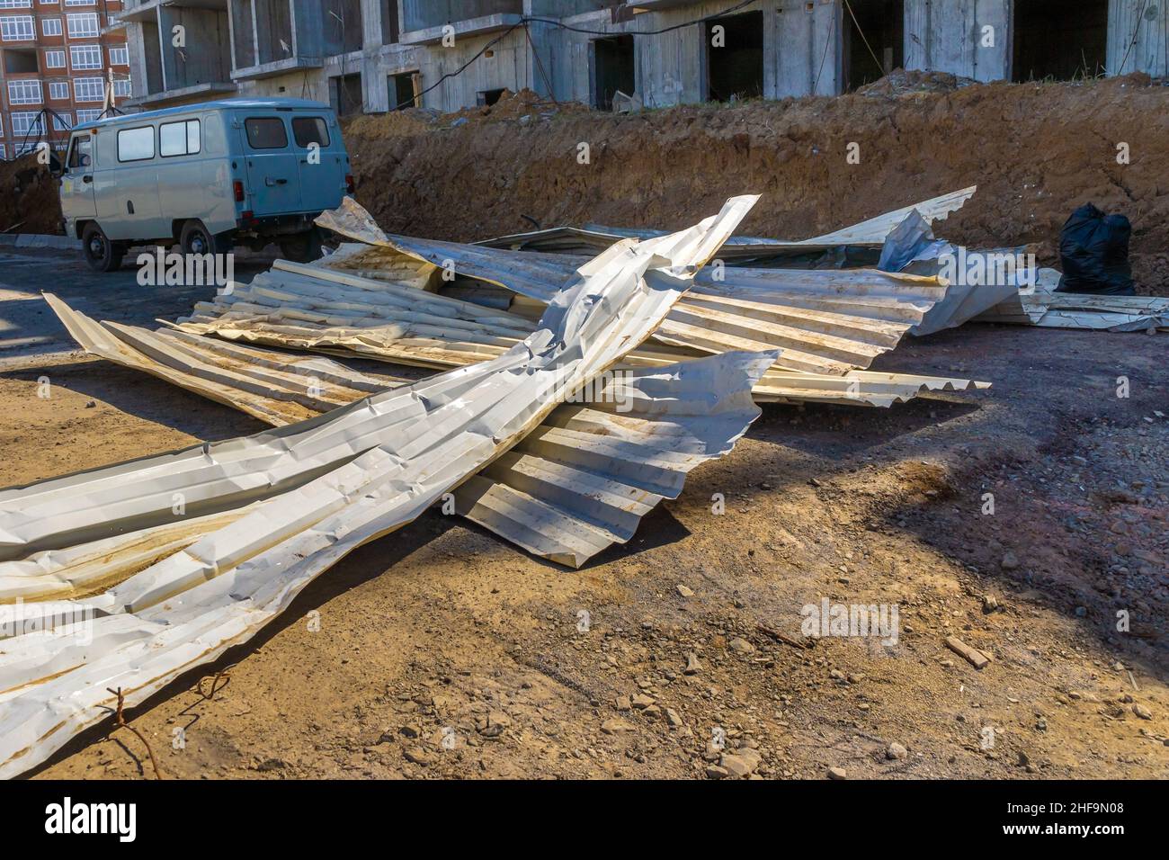deformed metal profiled sheets lie at a dead end after the dismantling ...
