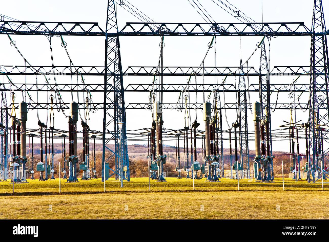 electricity relay station with high-voltage insulator and power lines ...