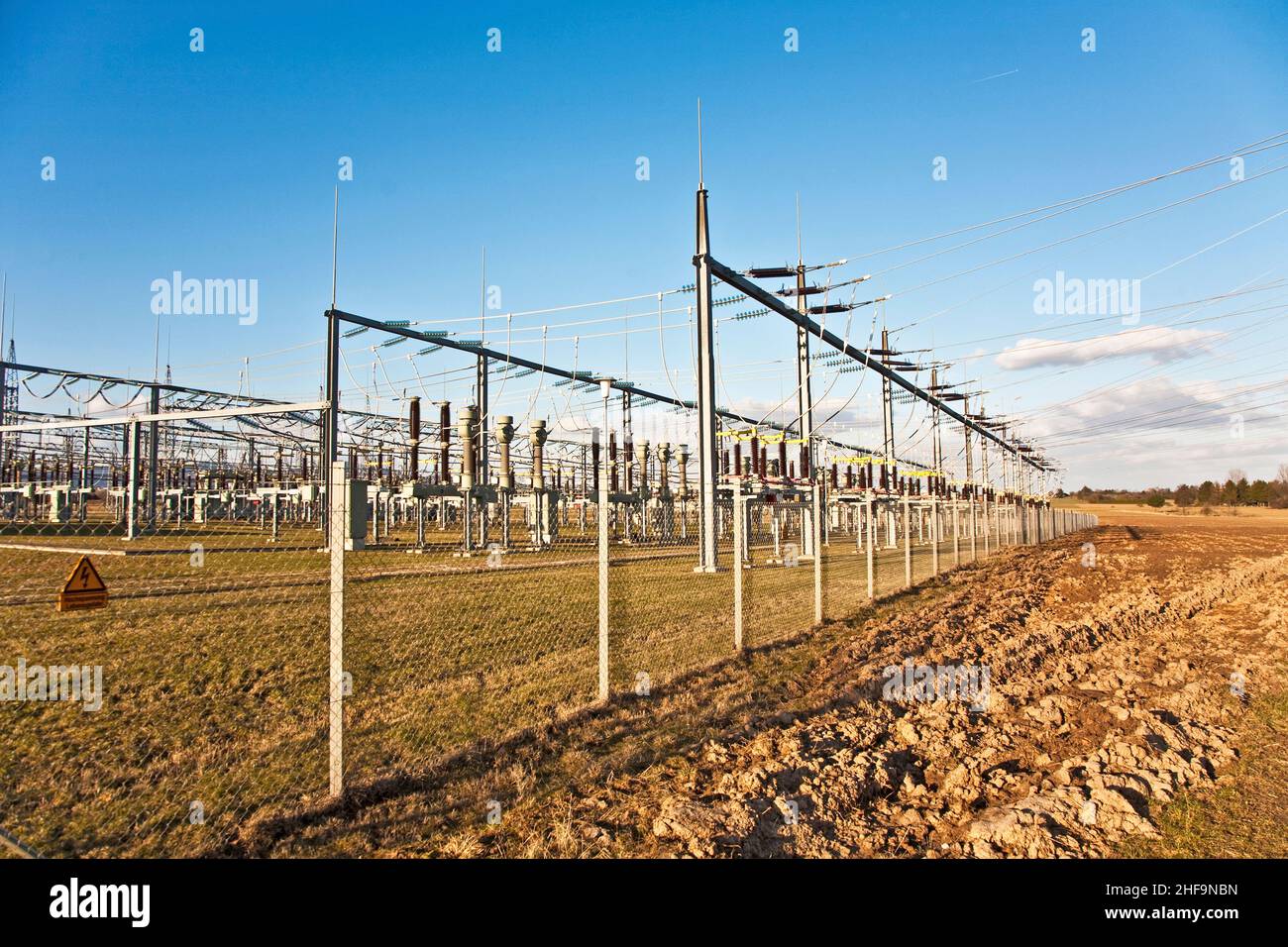 electricity relay station with high-voltage insulator and power lines ...