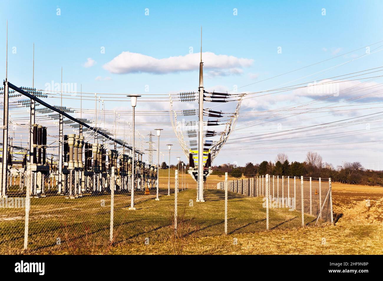 electricity relay station with high-voltage insulator and power lines ...