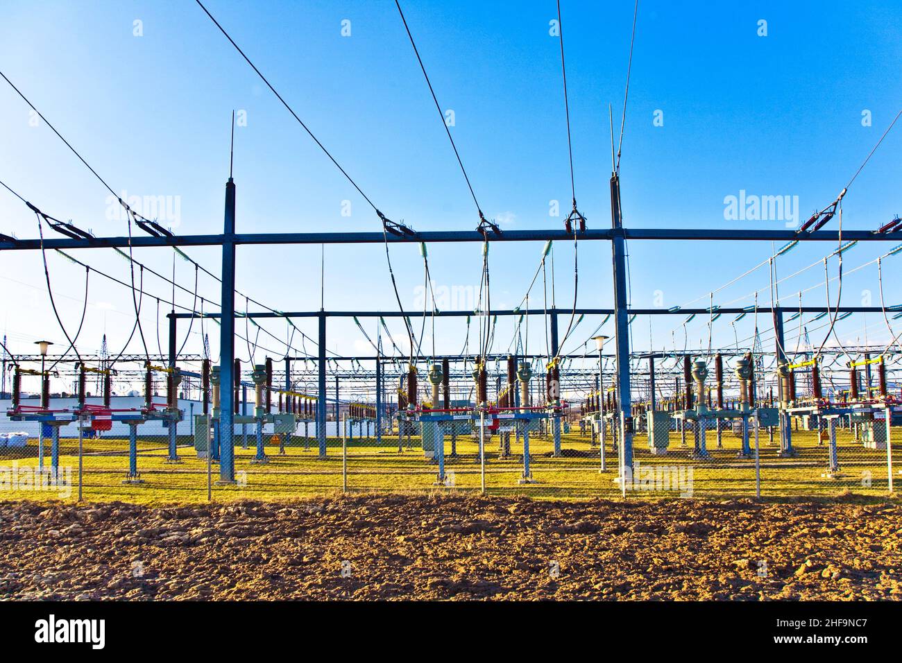 electricity relay station with high-voltage insulator and power lines ...