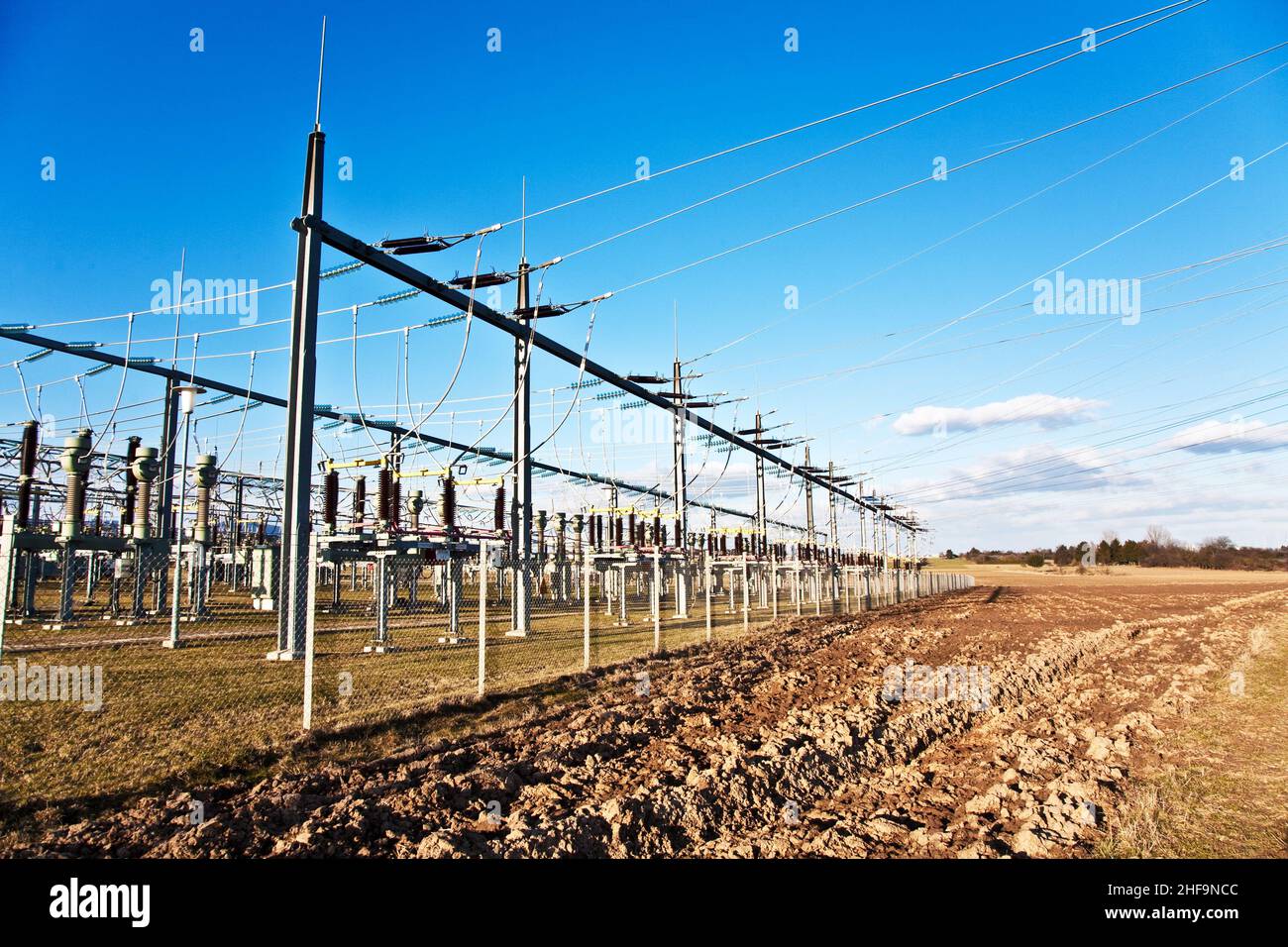 electricity relay station with high-voltage insulator and power lines ...