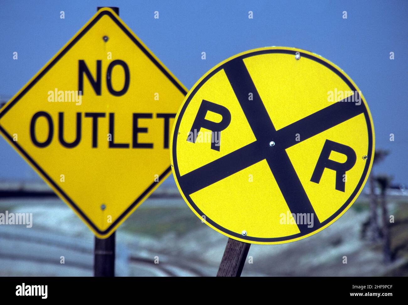 Yellow traffic warning signs for a dead end street and a railroad ...