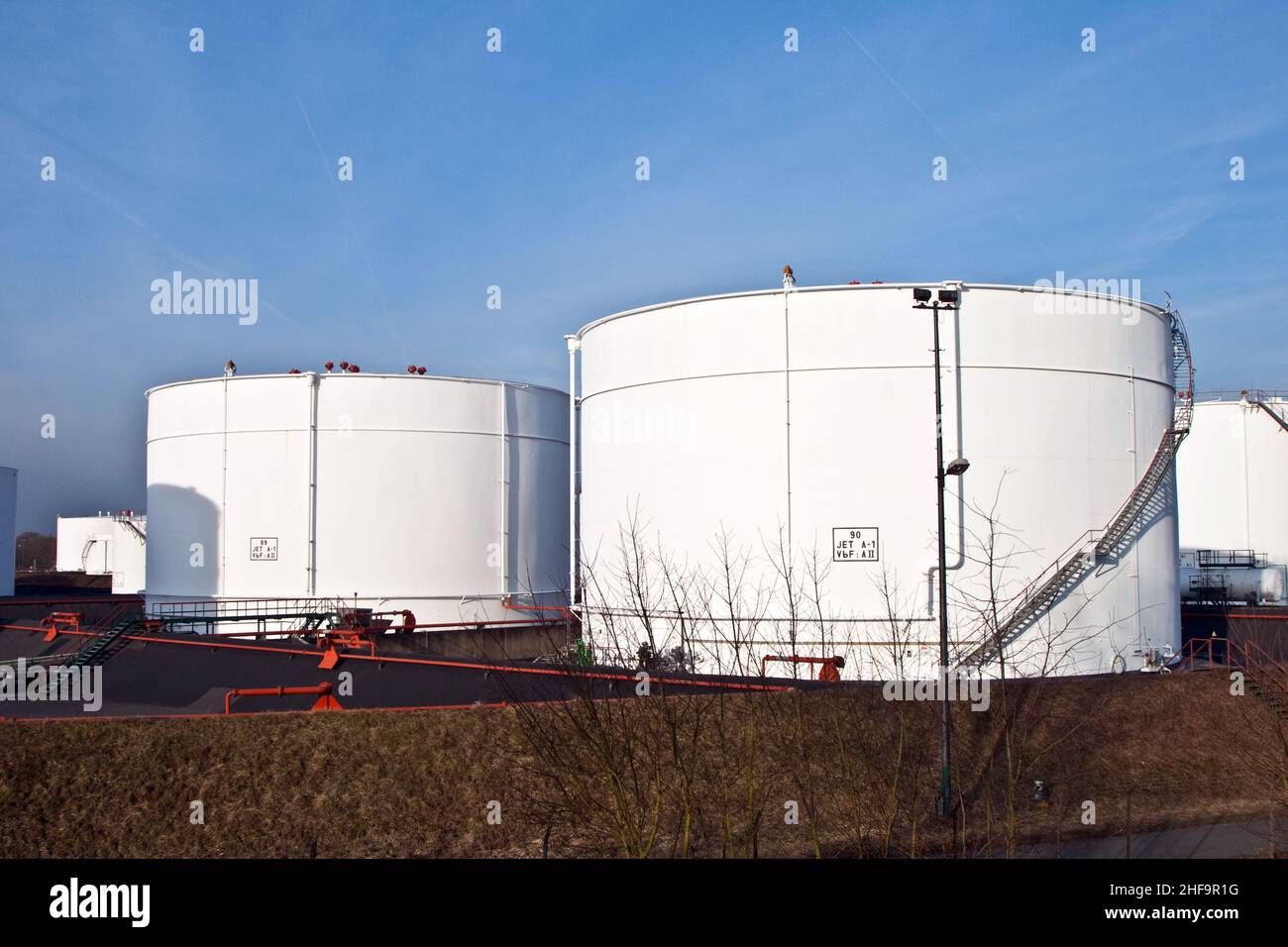 white tanks in tank farm with blue sky Stock Photo - Alamy