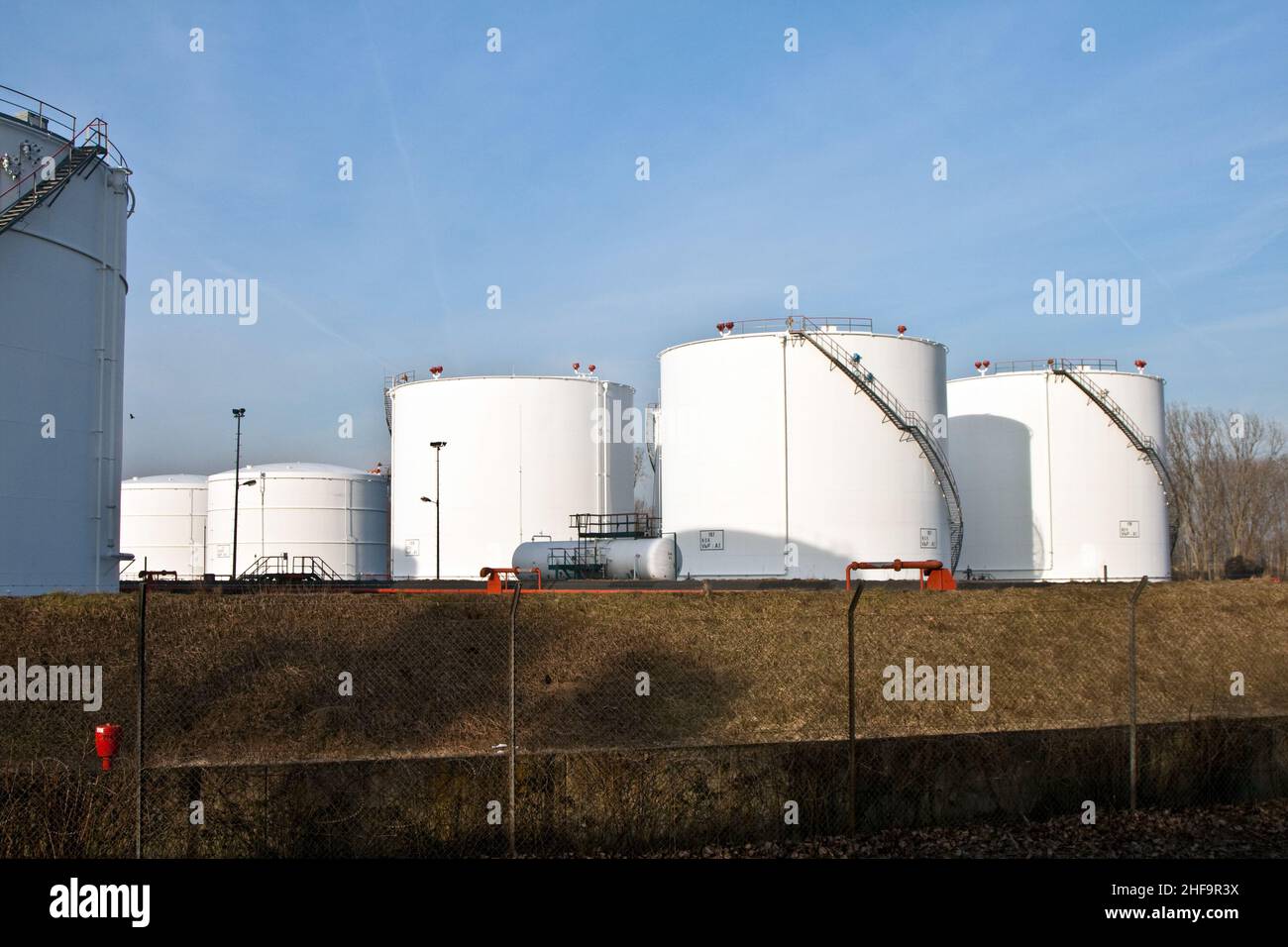 white tanks in tank farm with blue sky Stock Photo - Alamy