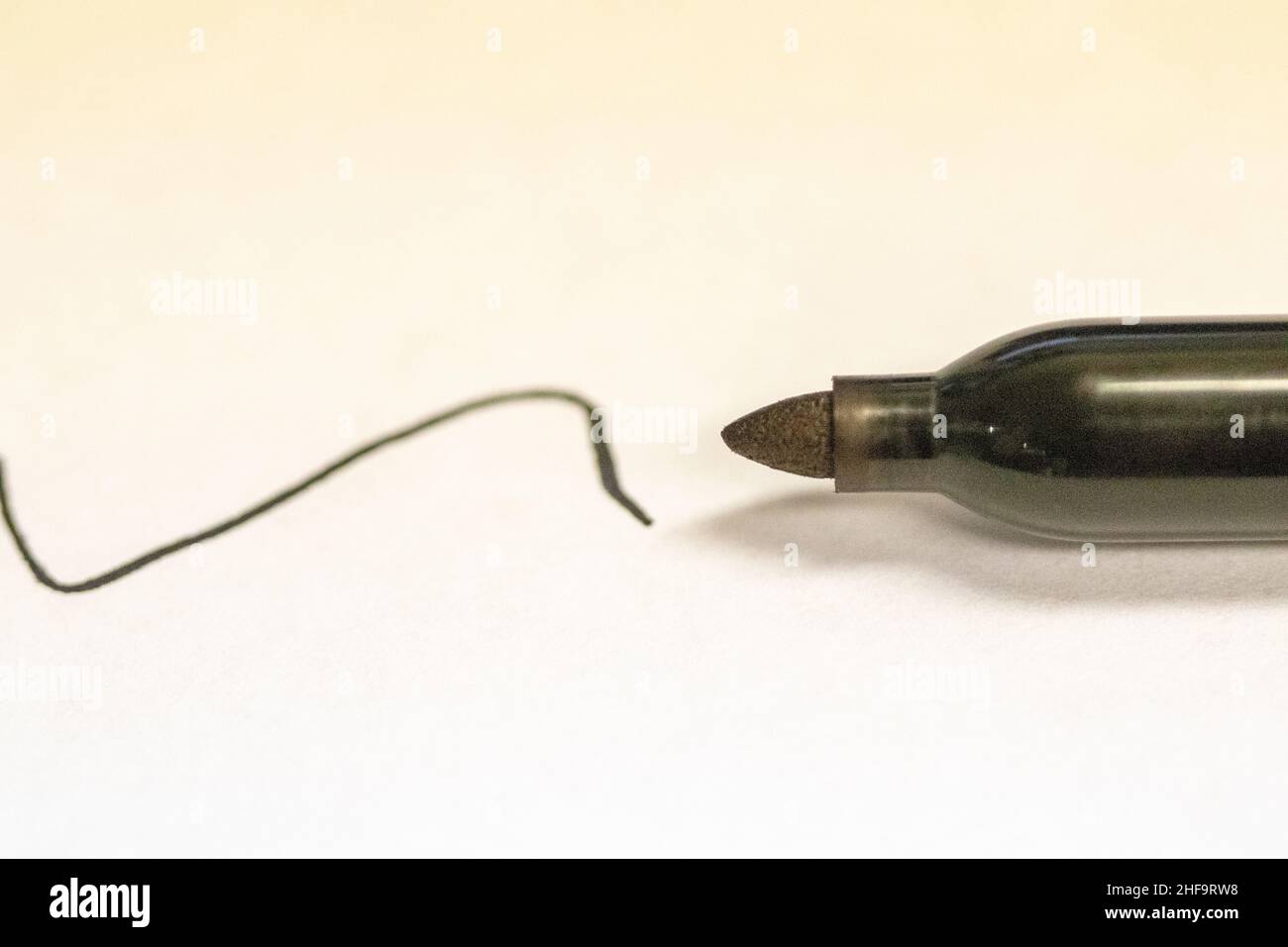 Permanent sharpie Marker close up written black line on white paper ...