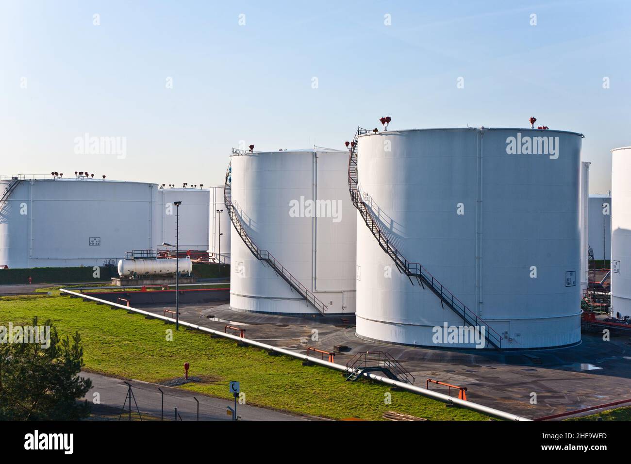 white tanks in tank farm with blue clear sky Stock Photo - Alamy