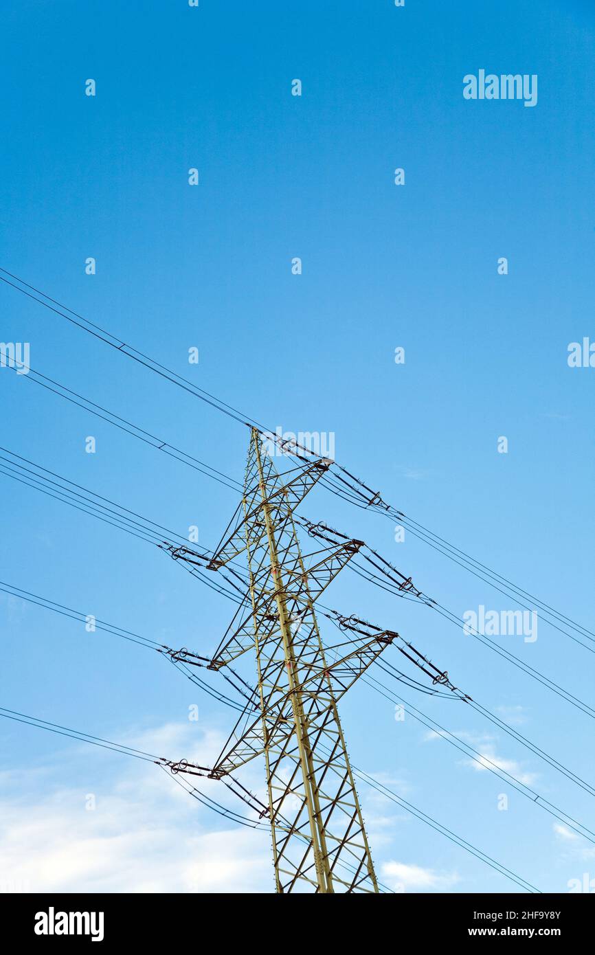 electrical pylon under blue sky, power line cable Stock Photo - Alamy