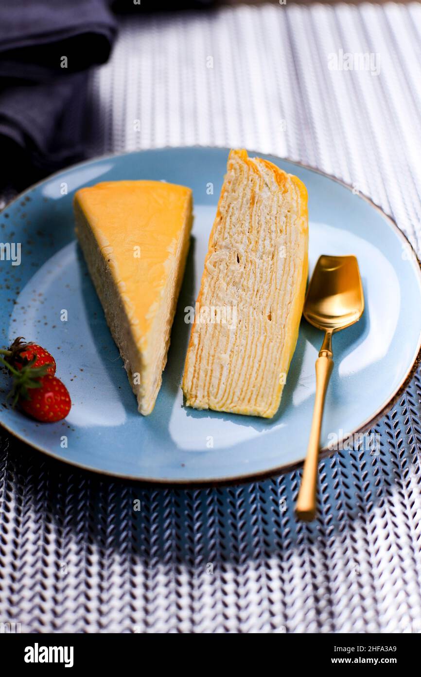 Lemon Mille Crepes (Thousand Layer Cake) on Blue Plate Stock Photo - Alamy