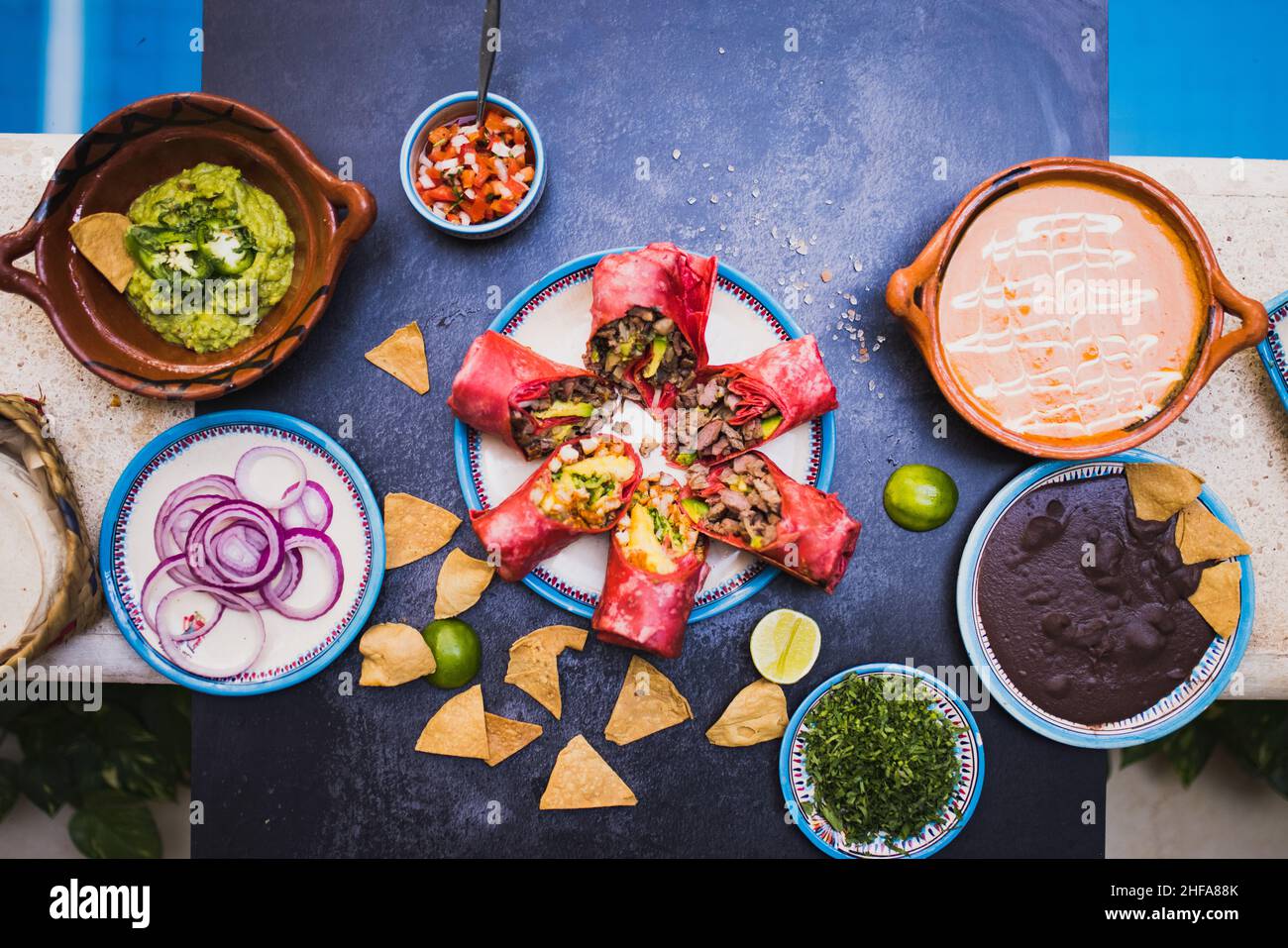 Delicious traditional Mexican condiments and dishes on dark surface ...