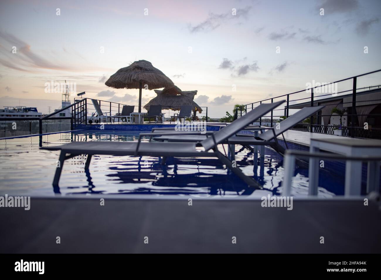 Astonishing view of shallow pool and beach beds with sunset as ...