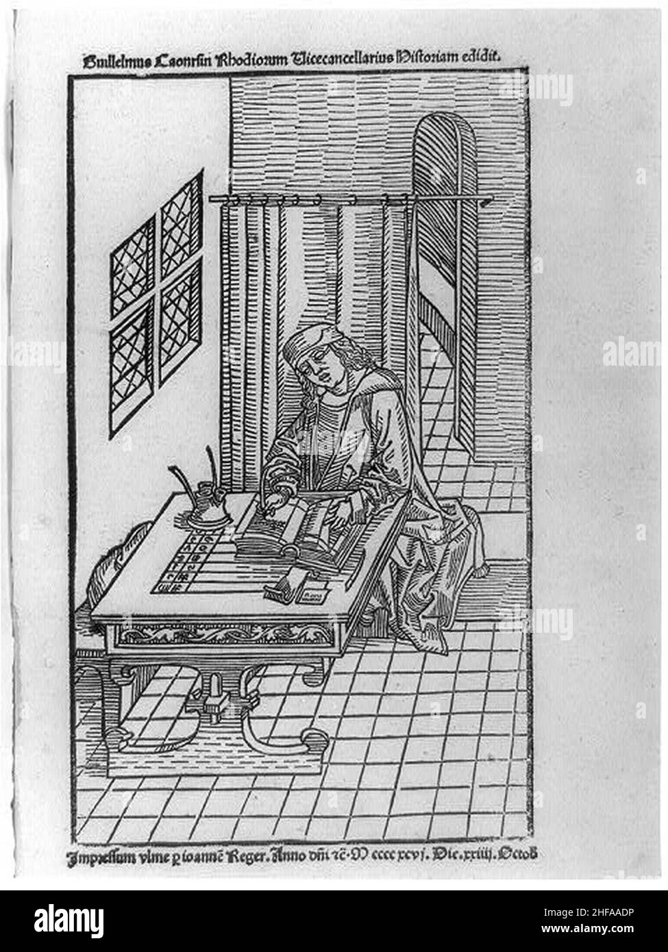 Seated figure writing at desk Stock Photo - Alamy