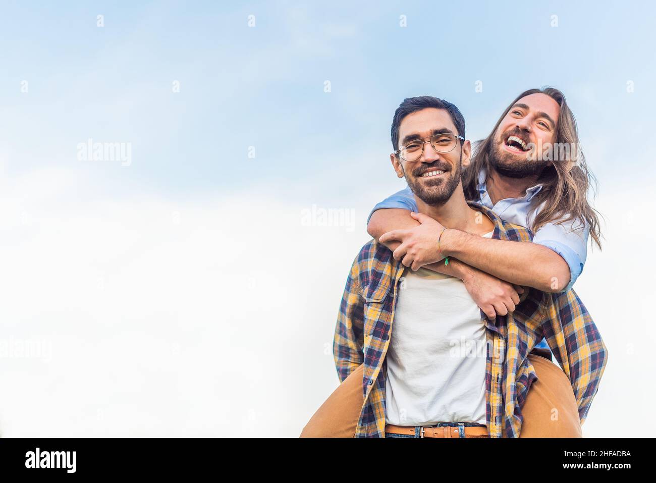 A young man carrying his partner on his back Stock Photo - Alamy