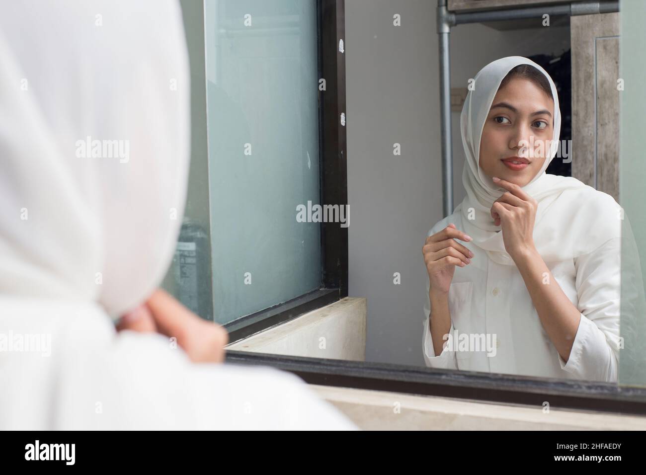Young asian muslim woman washing face in room Stock Photo - Alamy