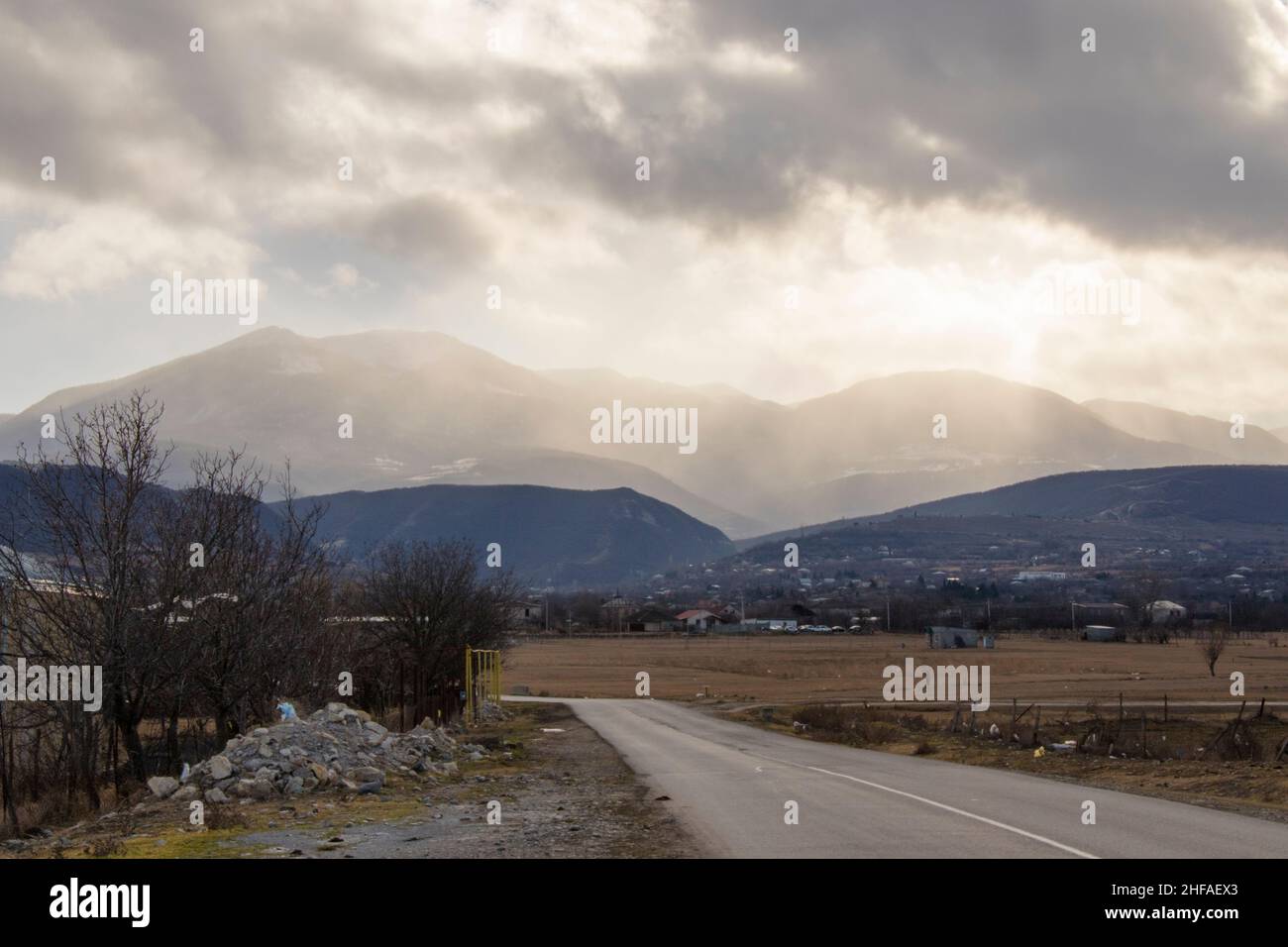 Mountain and town landscape during sunset in Kaspi, Georgia Stock Photo ...