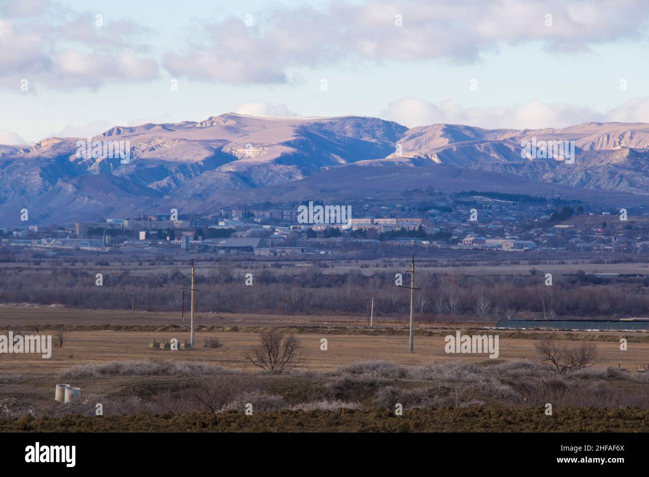 Mountain and town landscape during sunset in Kaspi, Georgia Stock Photo ...