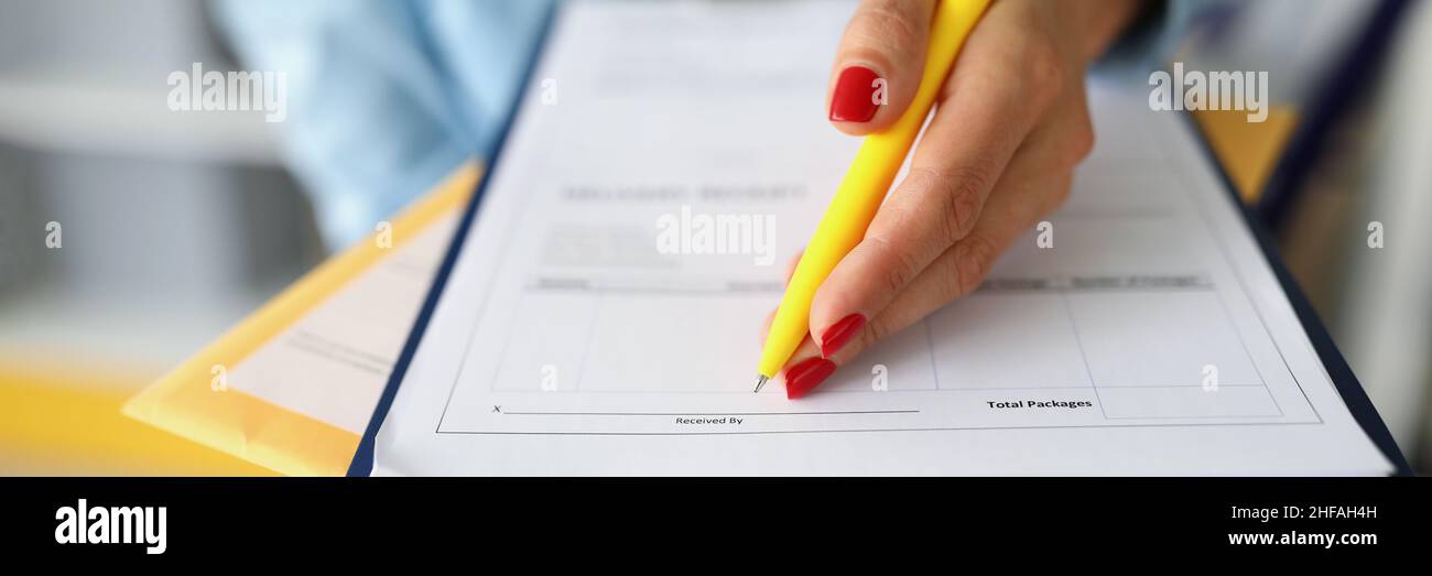 Female hands hold a package and delivery document Stock Photo - Alamy