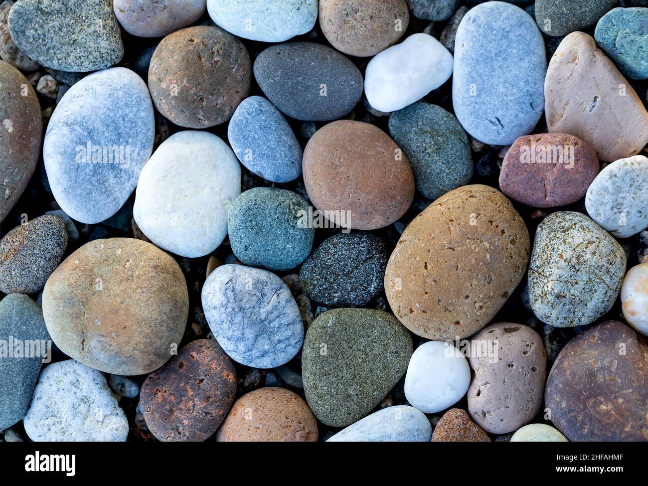 Round flat colorful stones on the bank of Baikal lake. Natutal mosaic ...
