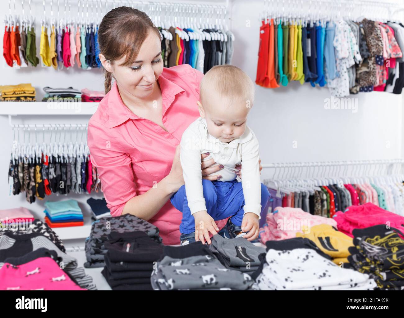 female with kid is picking clothes Stock Photo - Alamy