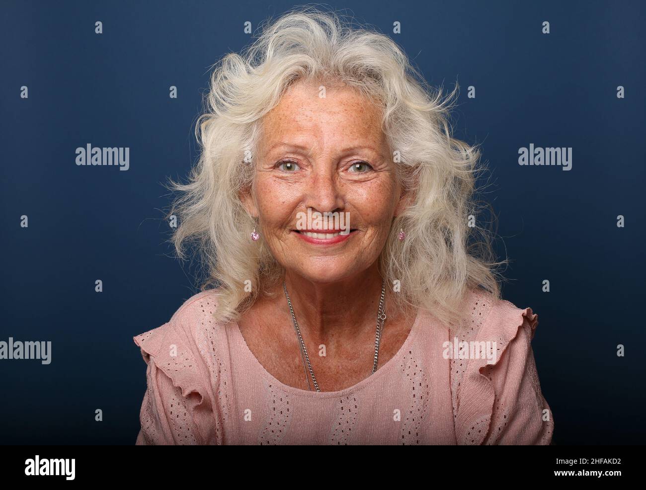 Portrait of a beautiful happy woman in front of a colored background ...