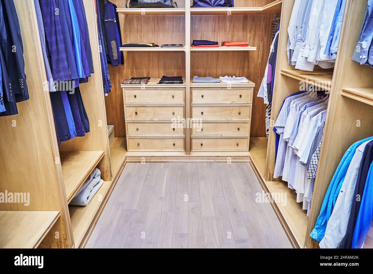 Stylish walk in closet with furniture of maple solid and veneer wood ...