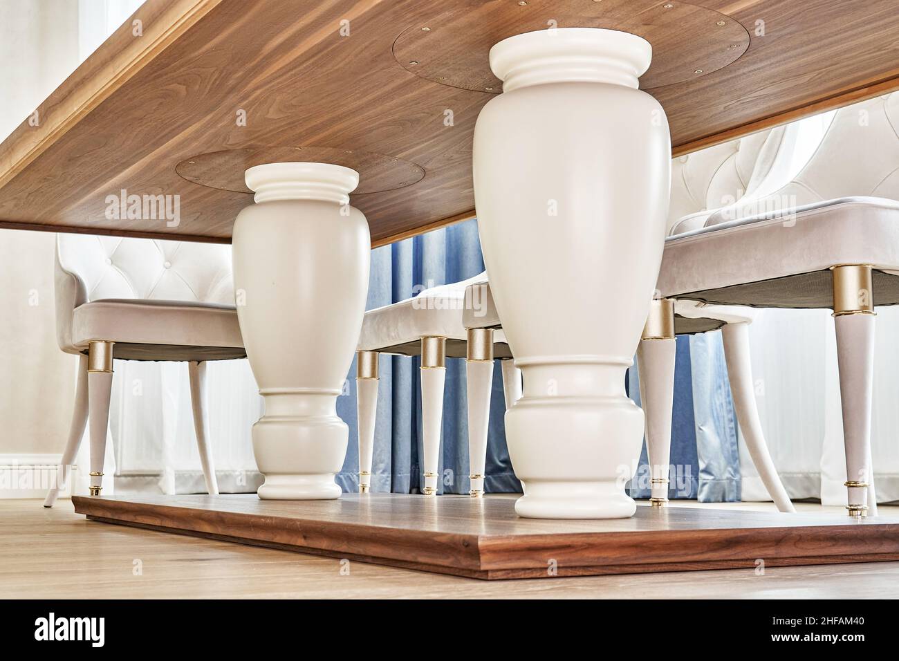 Massive turned white legs of luxury vintage dining table with top of ...