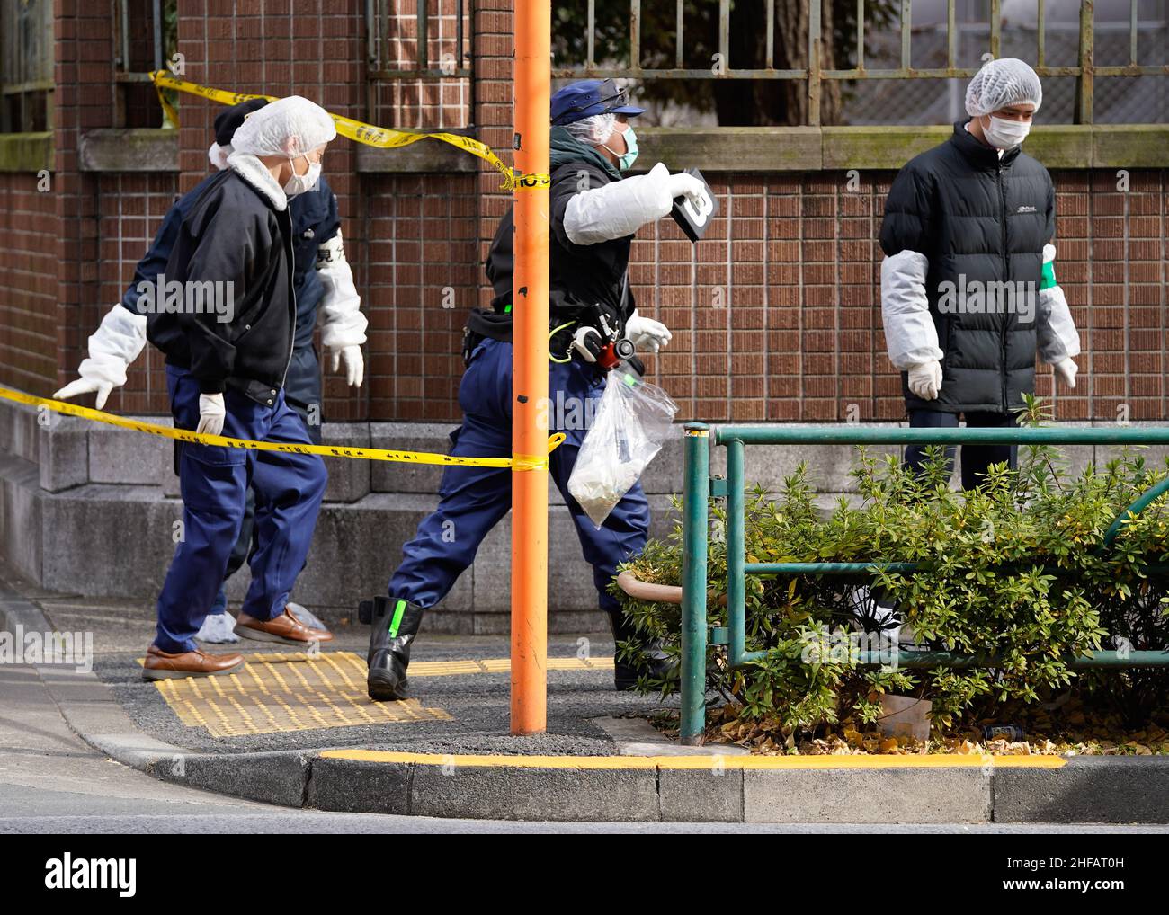 Tokyo, Japan - Police investigators prepare to inspect an area leading ...