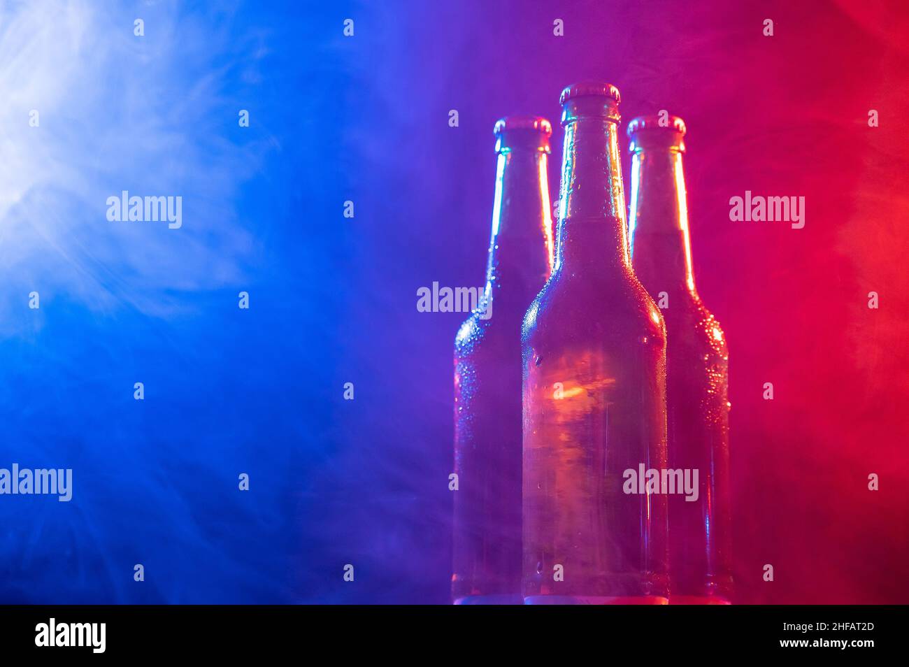 Three bottles of beer in a blue-pink mist Stock Photo - Alamy