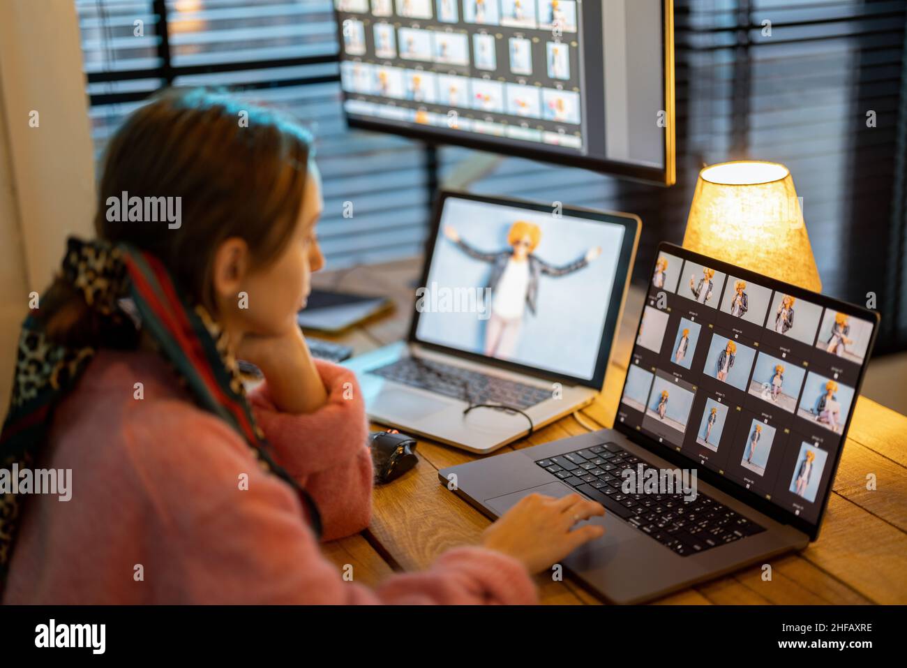 Photographer editing photos at home office Stock Photo - Alamy