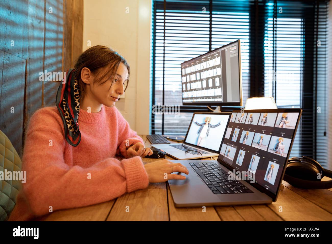 Photographer editing photos at home office Stock Photo - Alamy