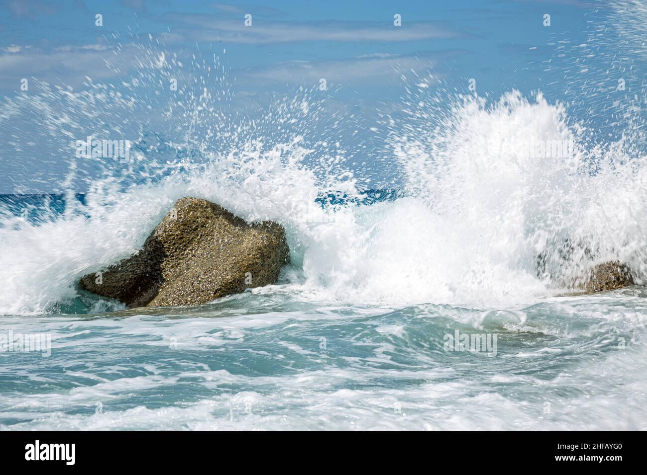 High wave breaking on the rocks of the coastline in Italy Stock Photo ...