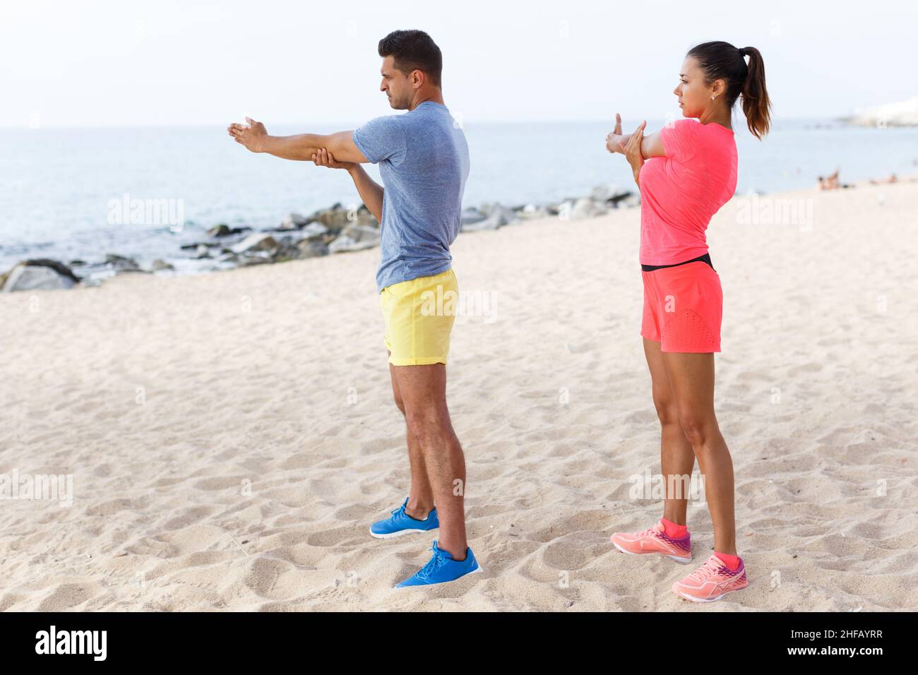 Couple training on beach Stock Photo - Alamy