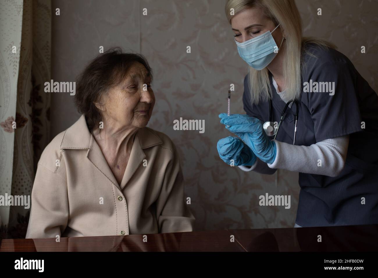 Nurse giving an injection to senior woman Stock Photo - Alamy