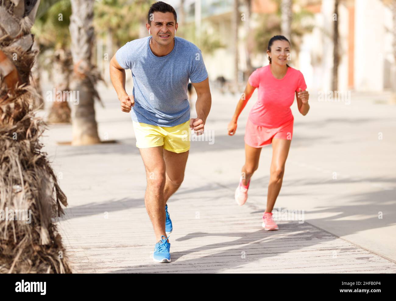 Couple running outdoors Stock Photo - Alamy