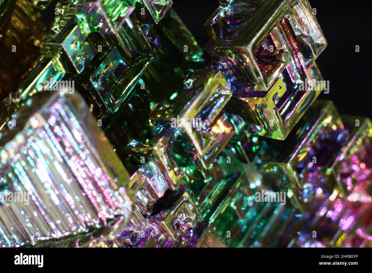 Synthetic bismuth (Bismuthum) crystal with rainbow oxide film close up ...