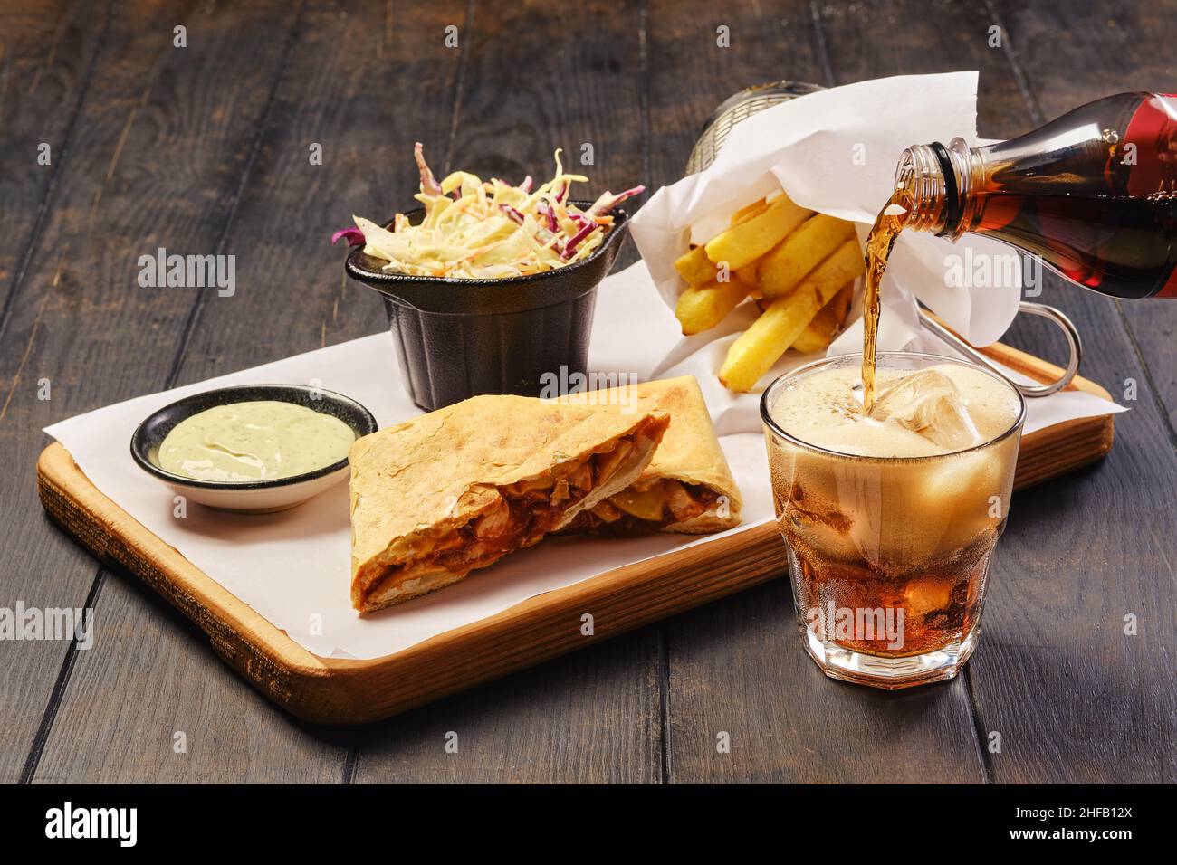 Pouring cola in a glass. Fast food snack concept Stock Photo - Alamy