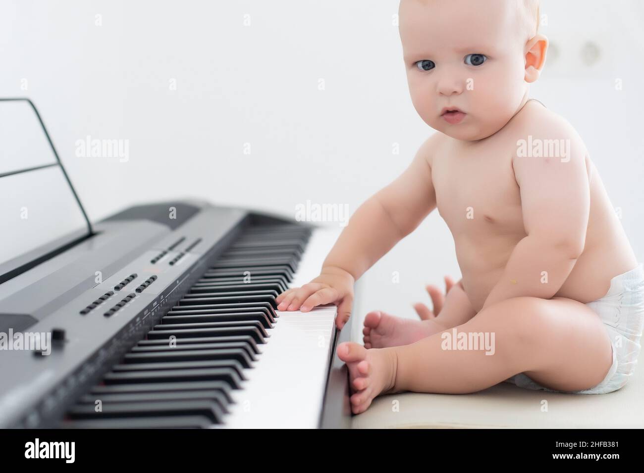 child playing synthesizer on white background Stock Photo - Alamy